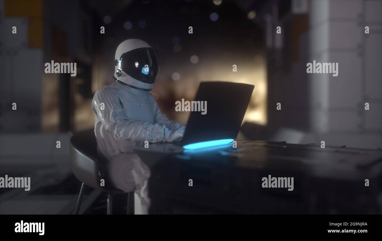Astronaut works on his science laptop in futuristic spaceship, room. 3d ...