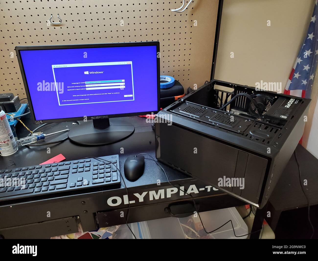 Photograph of desk with an open desktop PC case and a monitor ...