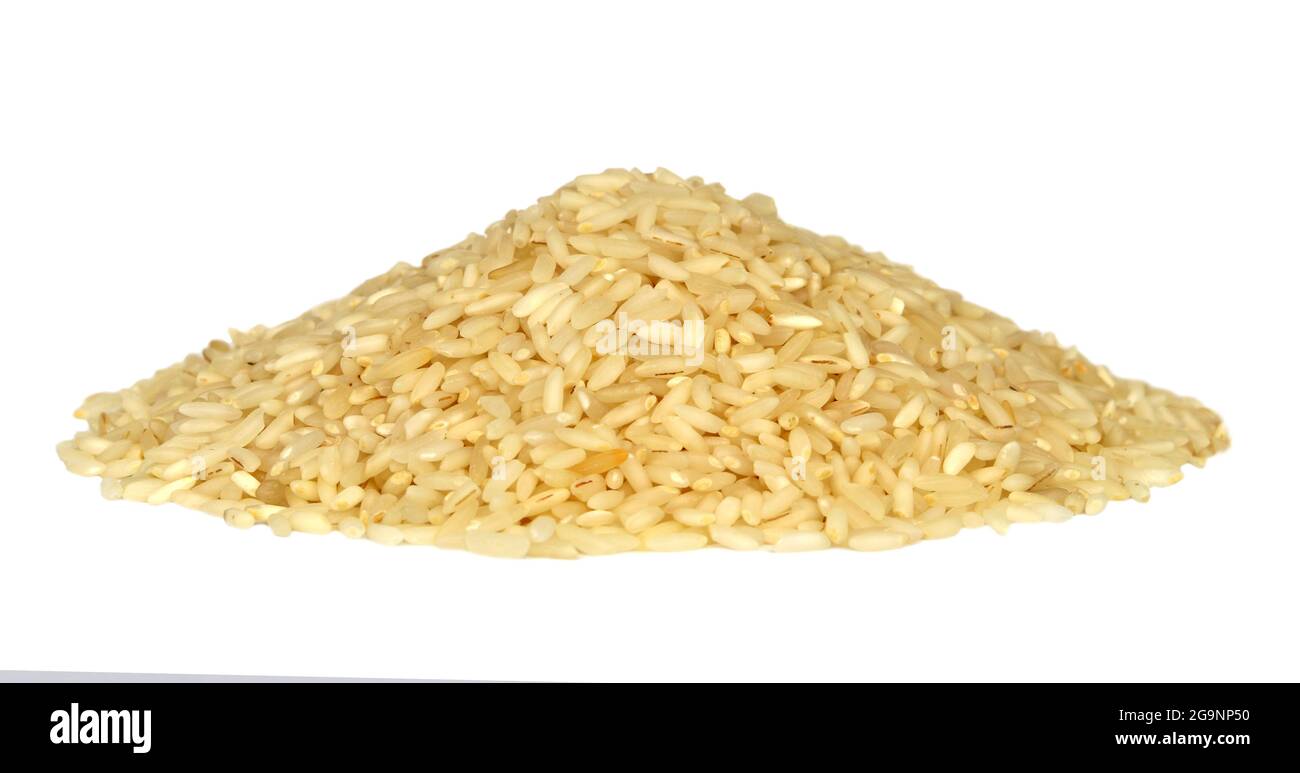 Dry brown rice in a small pile isolated on a white background Stock ...