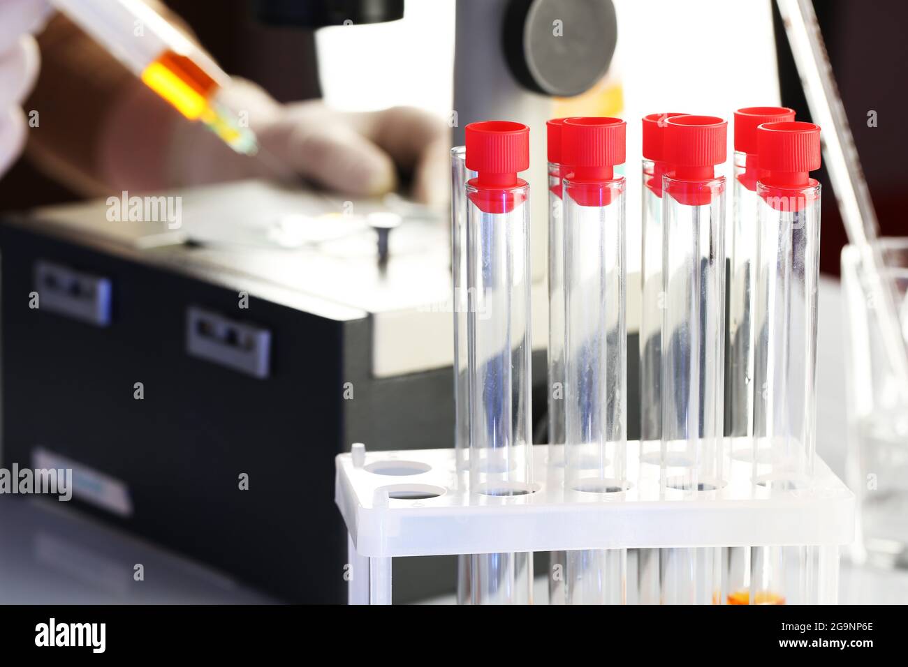 Assistant hand in gloves making analysis in laboratory with microscope ...