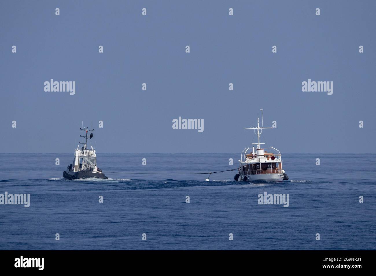 tugboat towing small boat old ship vessel Stock Photo - Alamy