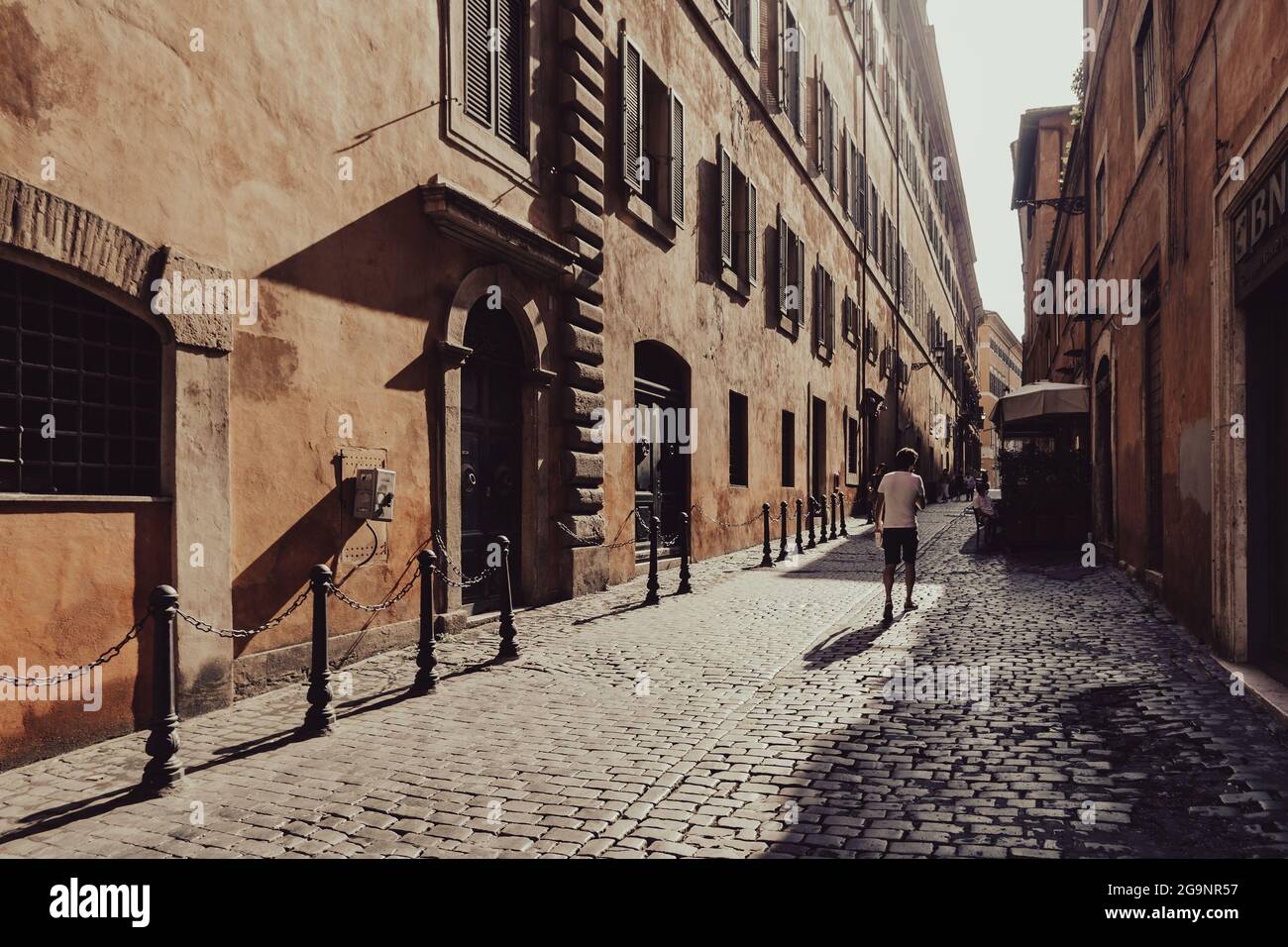Narrow ancient alley with cobblestone in the historic center of Rome ...