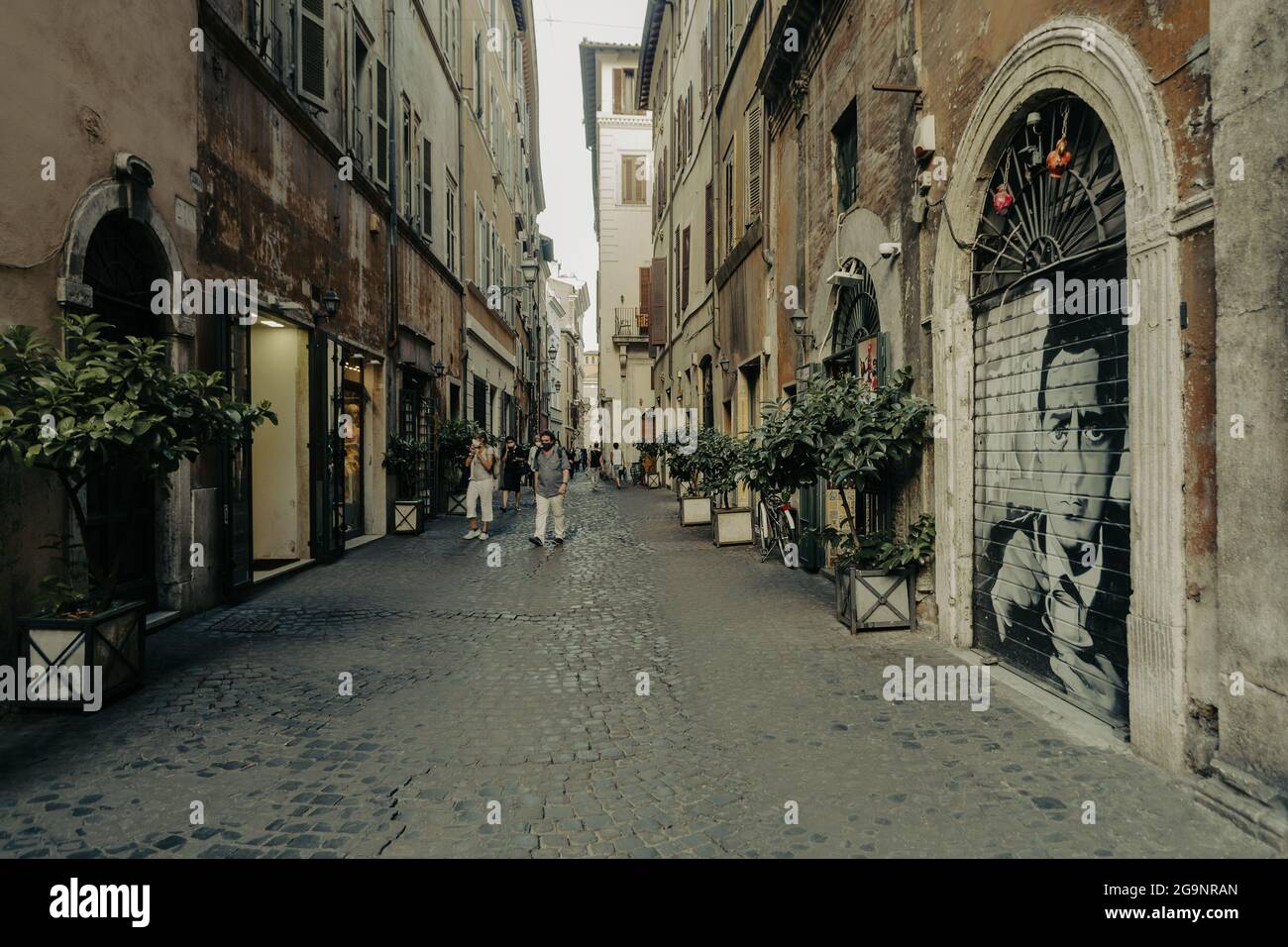 Narrow ancient alley with cobblestone in the historic center of Rome ...