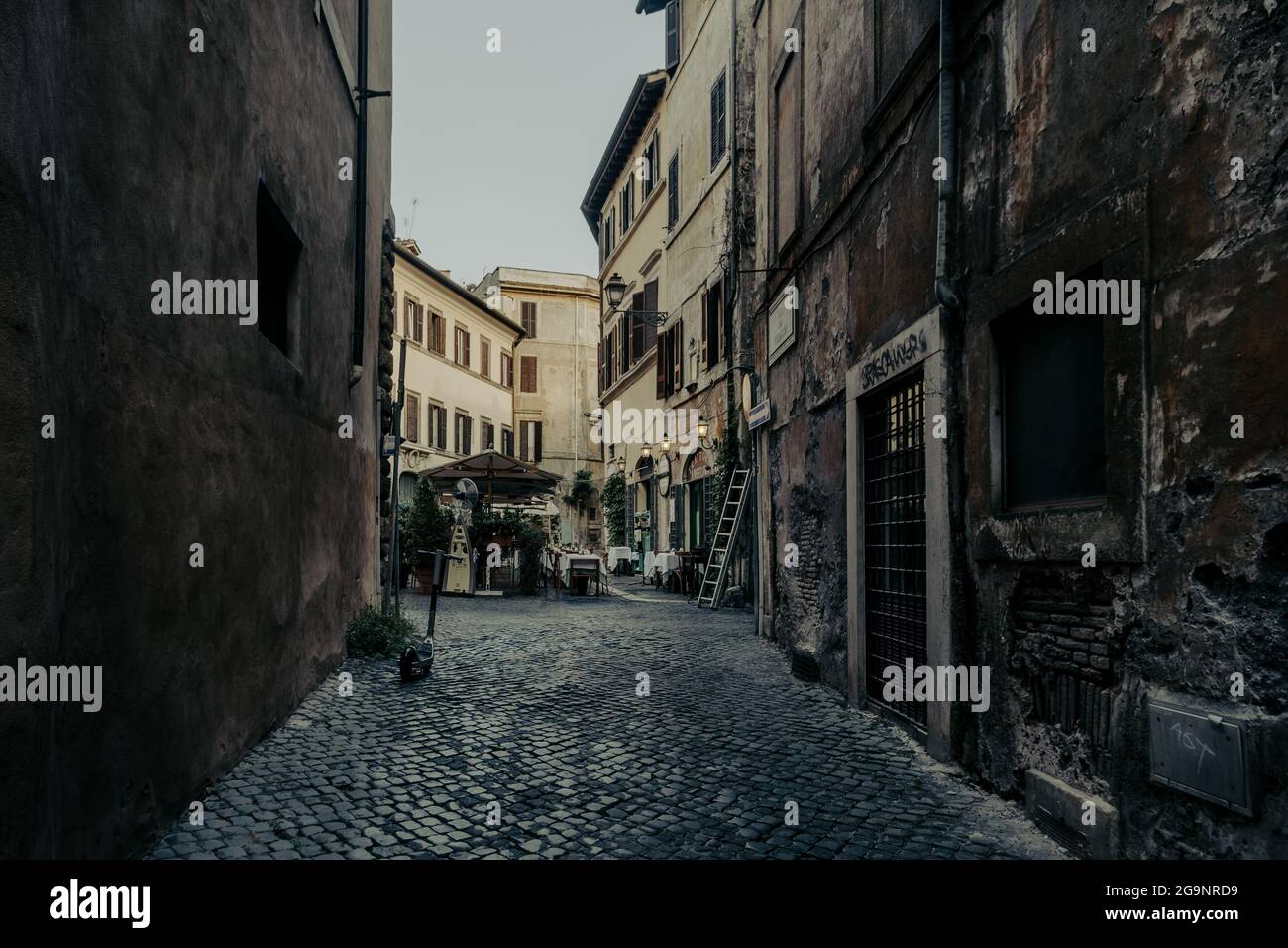 Narrow ancient alley with cobblestone in the historic center of Rome ...