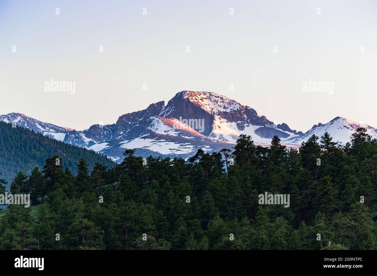Mountain Peak and Alpenglow at Sunset With Evergreen Forest of Trees in ...