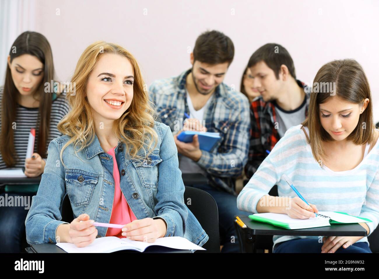 Group of students sitting in classroom Stock Photo - Alamy