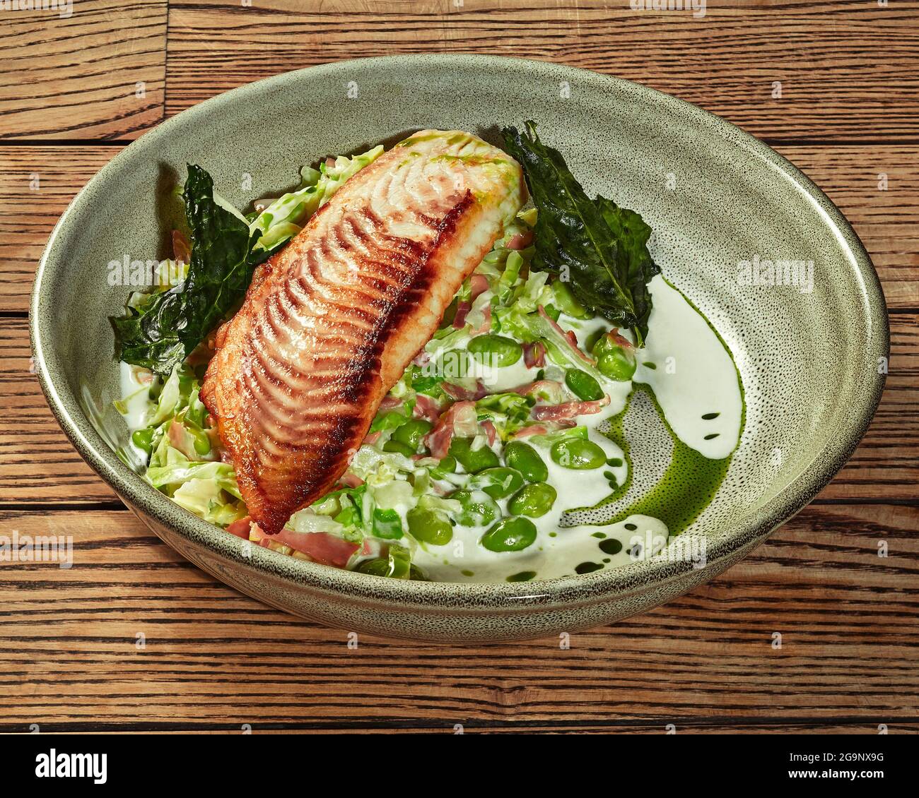 Baked dorado fillet with salad of greens, beans, ham and creamy ...