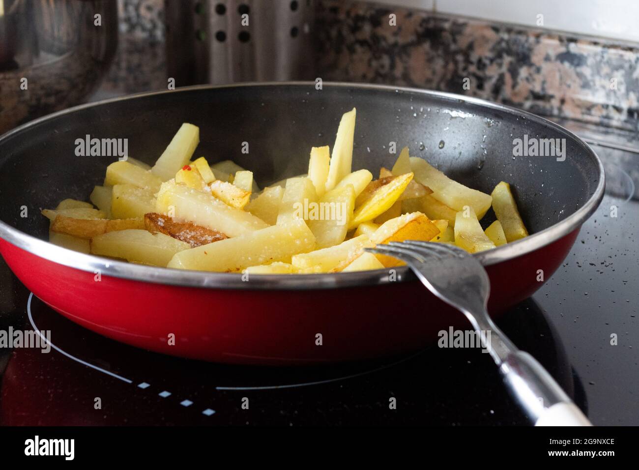 French fries in a pan almost ready to eat Stock Photo - Alamy