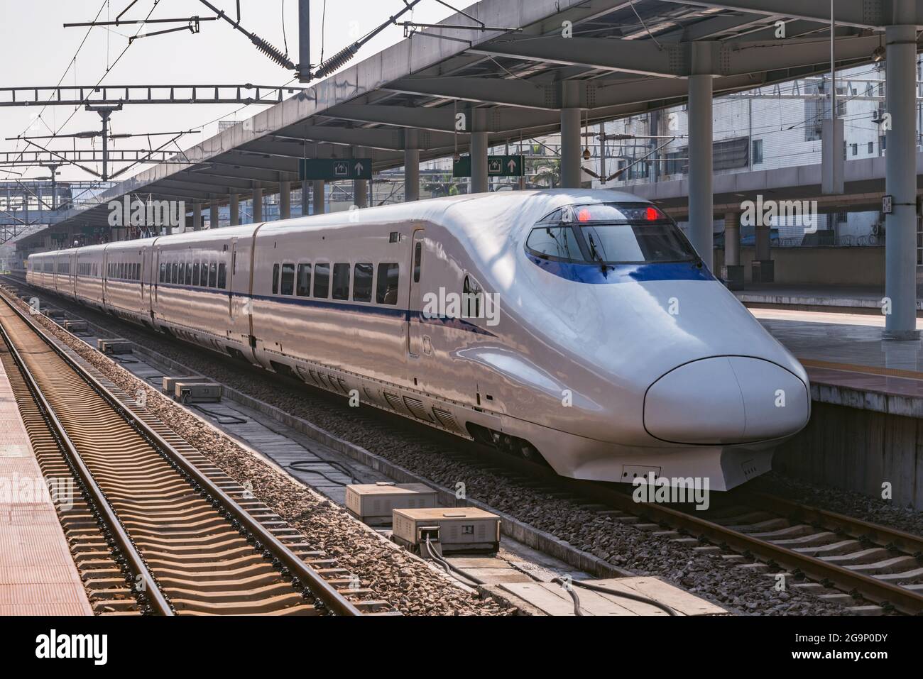 Passenger highspeed train stands by the platform at morning time. China ...