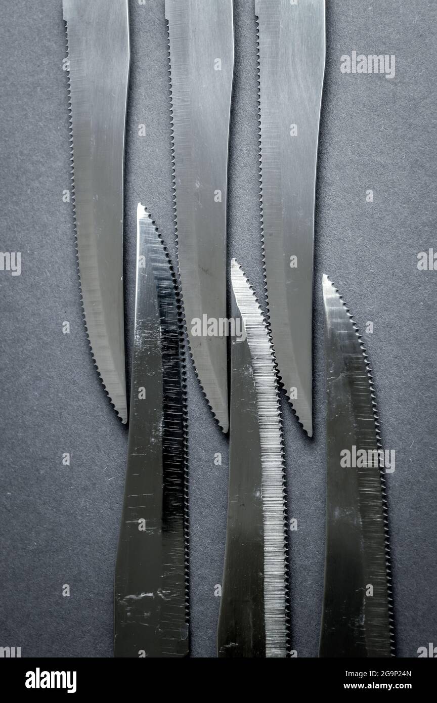 kitchen knife blades on dark gray background, black and white image ...
