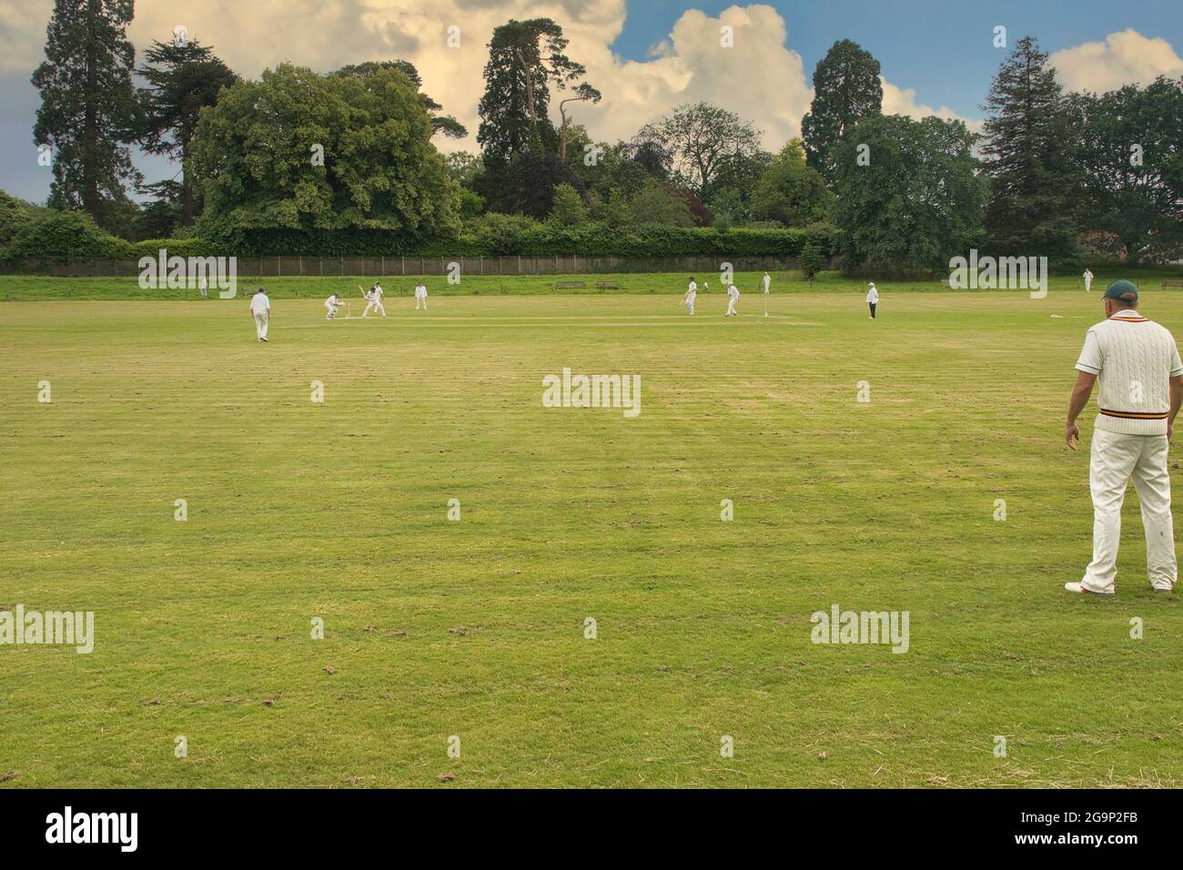 A traditional summer English country scene - cricket on a village green ...