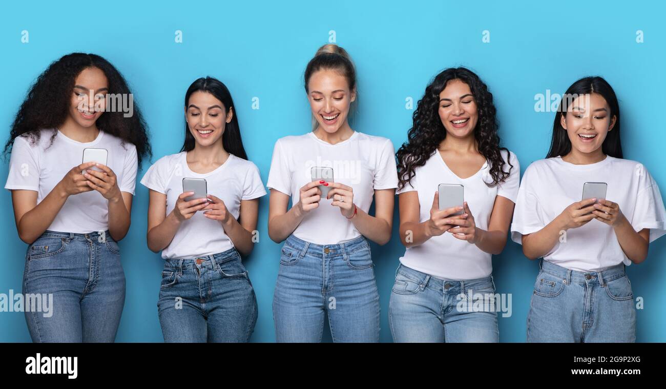Five Happy Multiracial Females Using Phones Standing On Blue Background ...