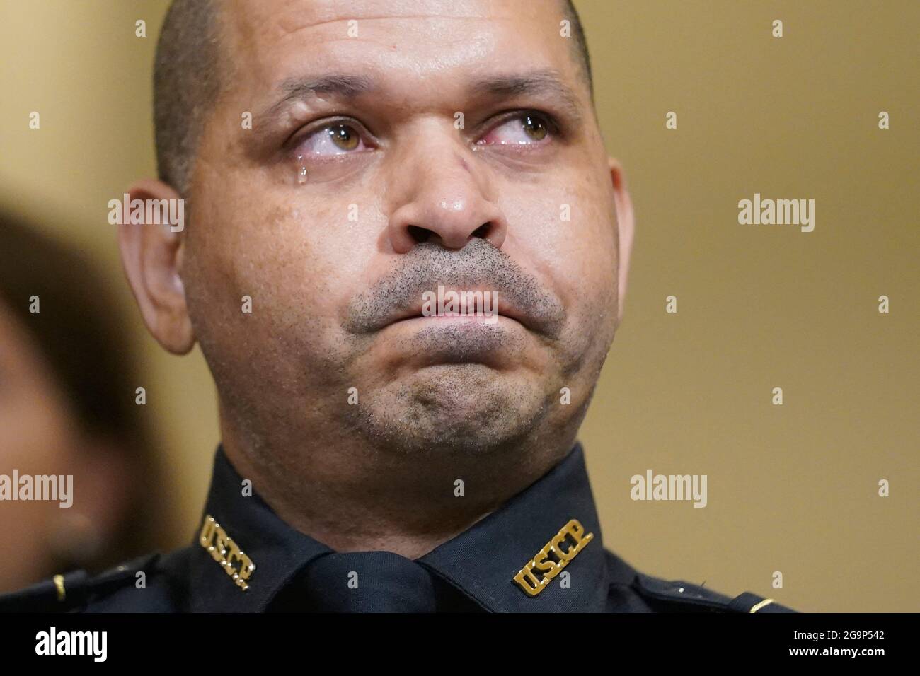 U.S. Capitol Police officer Aquilino Gonell cries as he watches a video ...