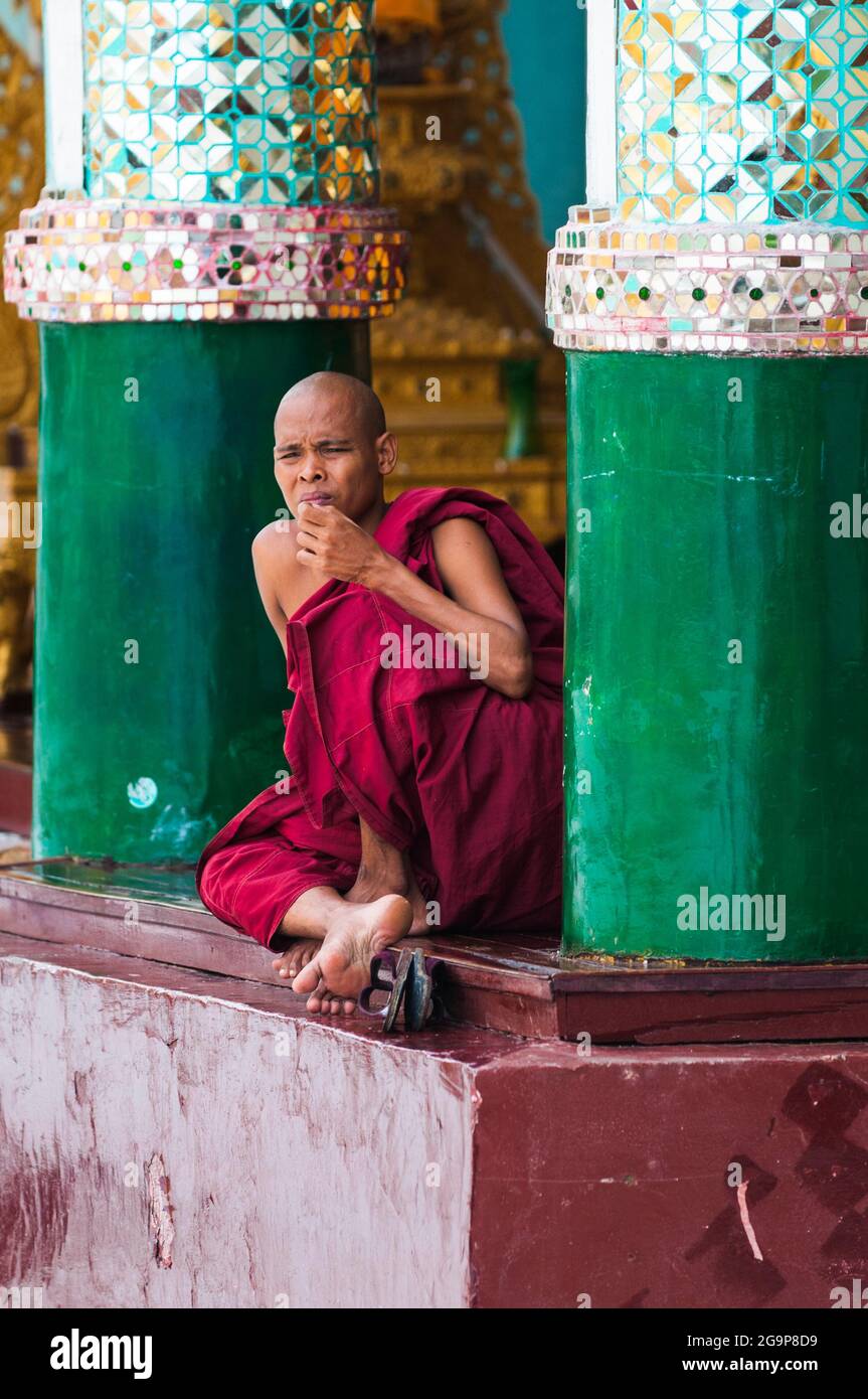 A monk poses in shwedagon pagoda, Yangon, Myanmar Stock Photo - Alamy