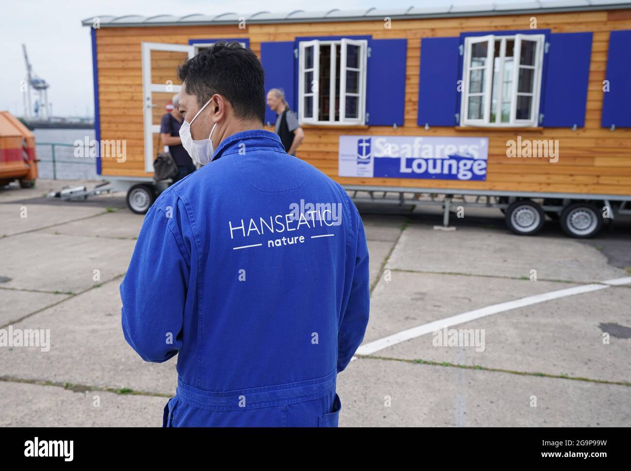 Hamburg, Germany. 27th July, 2021. A crew member of the "Hanseatic ...