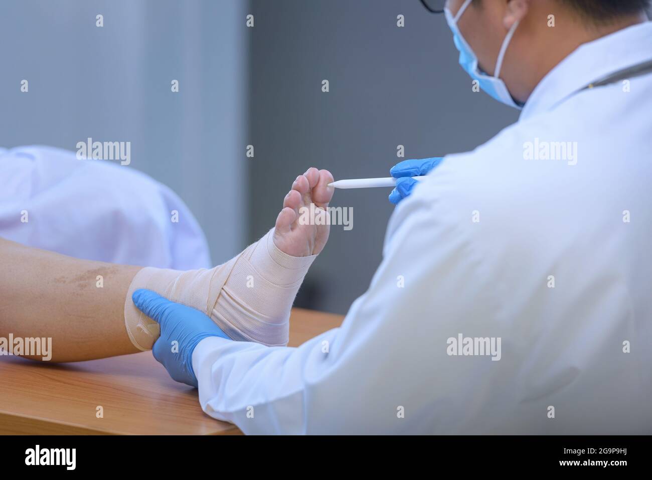 Feet holding with doctor,doctor analyzes and explains pain in the bones ...
