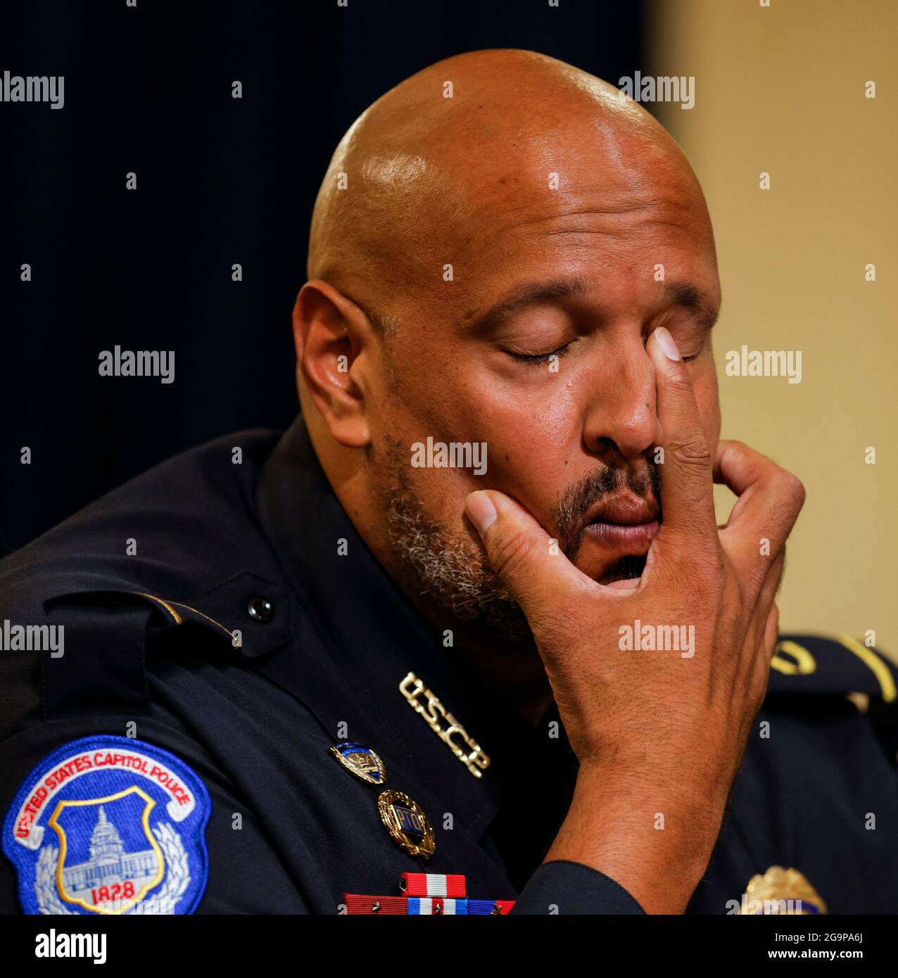 U.S. Capitol Police Officer Harry Dunn pauses while testifying during ...