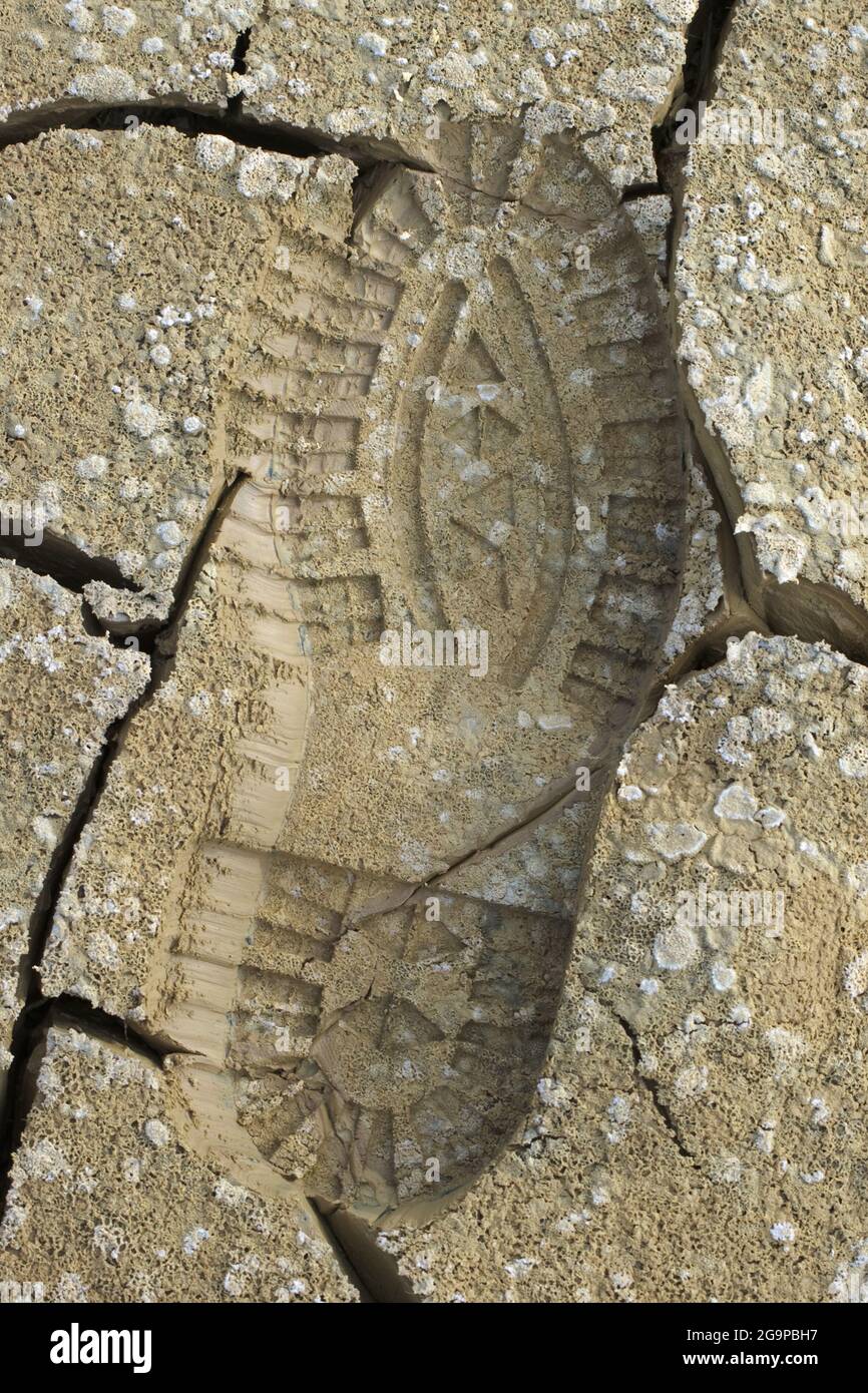 heavy footprint right on a muddy sand of a male boot Stock Photo - Alamy