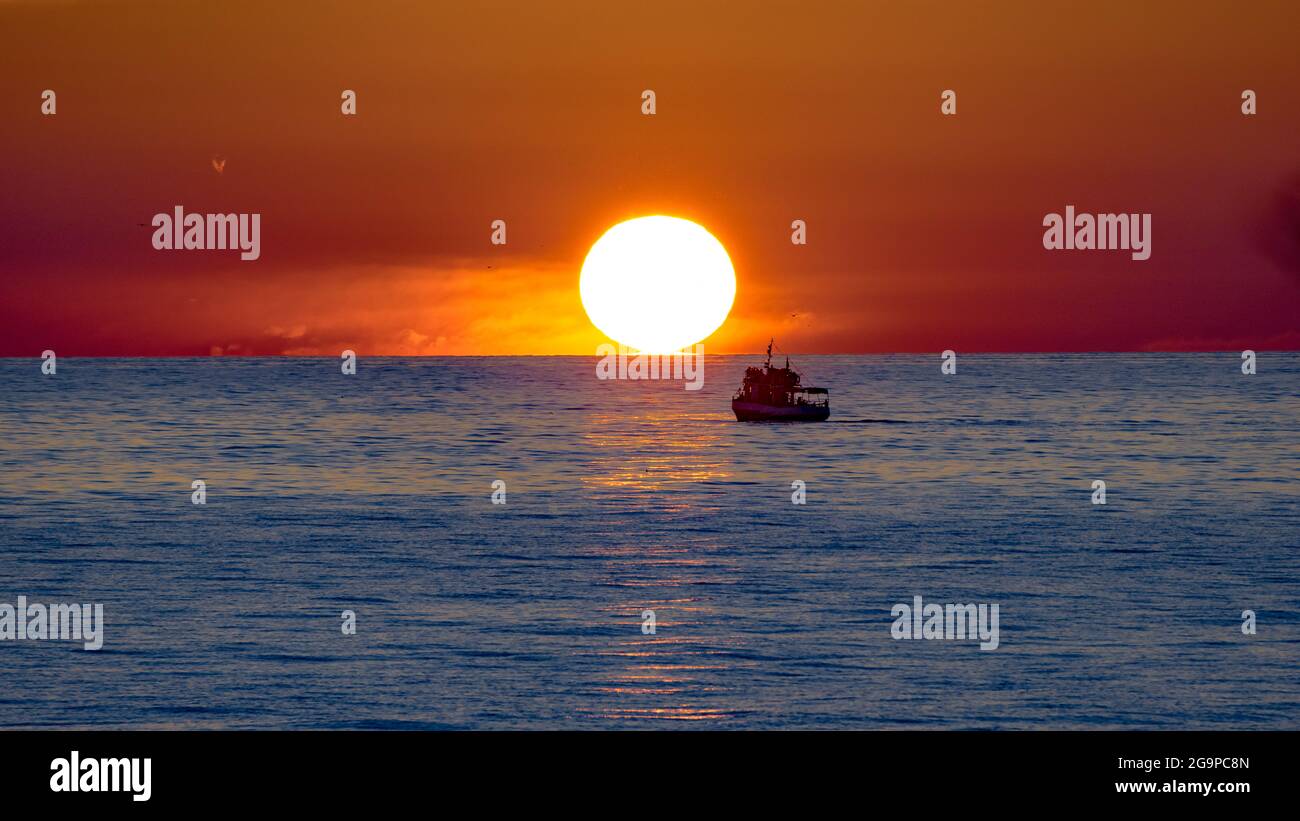 Boat in sunset Stock Photo - Alamy
