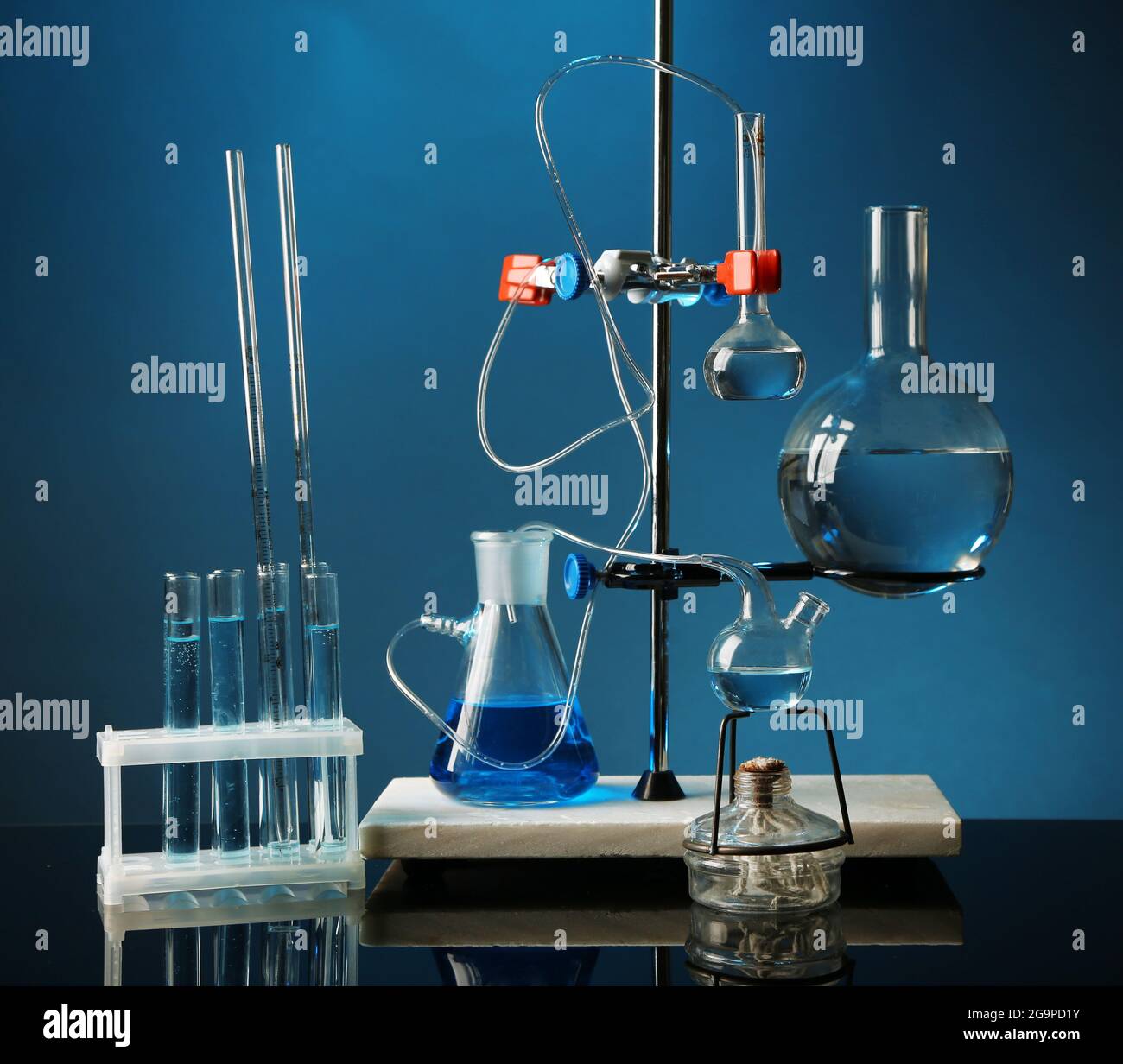 Fixed laboratory glassware on support on dark colorful background Stock ...