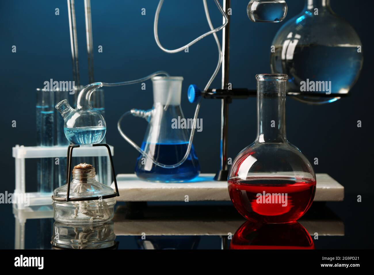 Fixed laboratory glassware on support on dark colorful background Stock ...