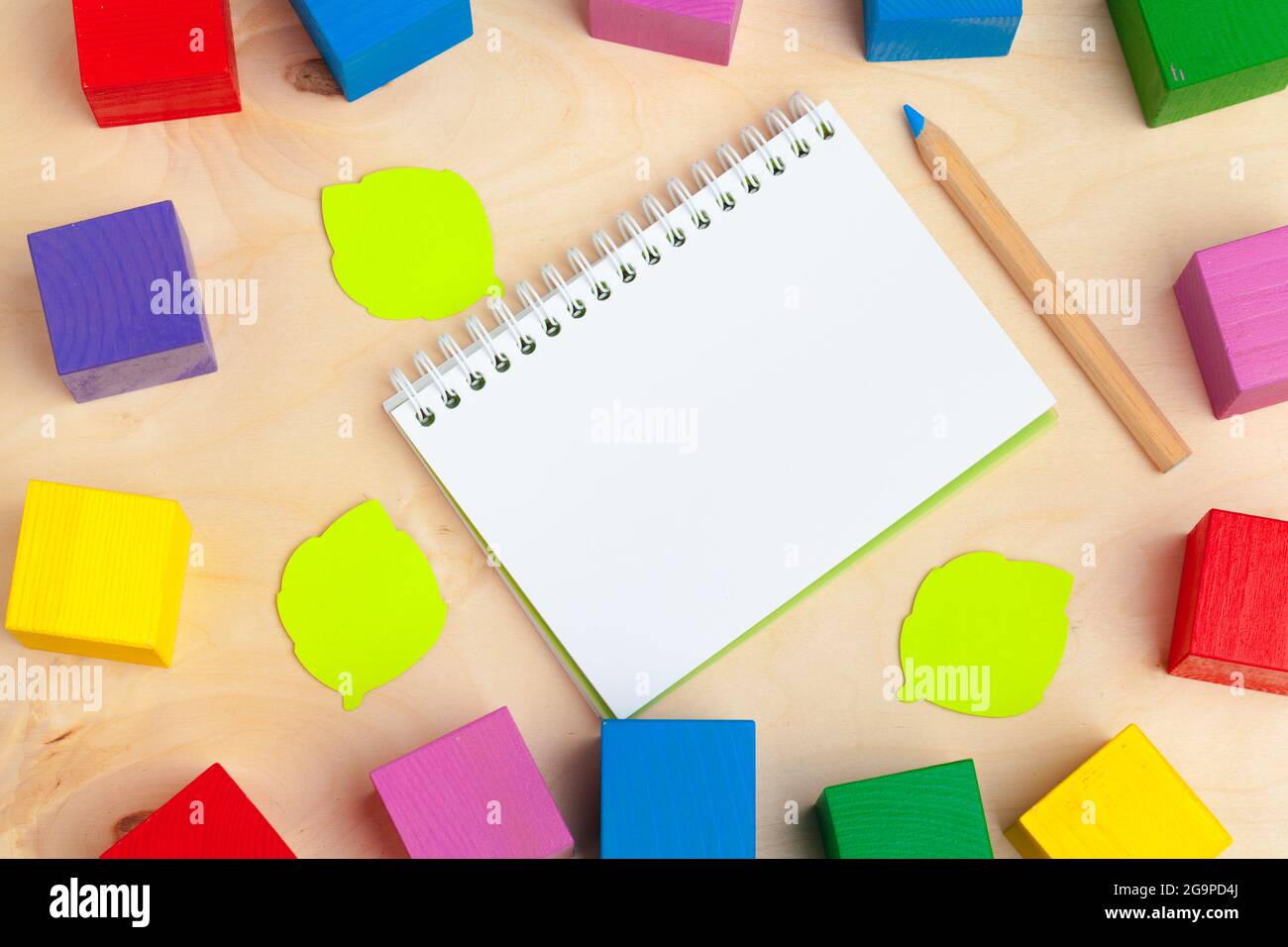 Notepad on wooden table and wood alphabet blocks Stock Photo - Alamy