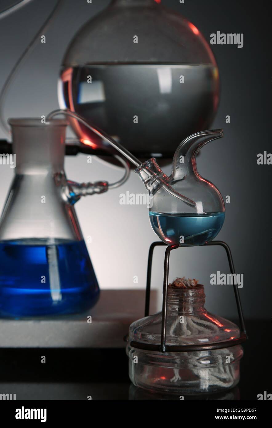 Fixed laboratory glassware on support on dark colorful background Stock ...