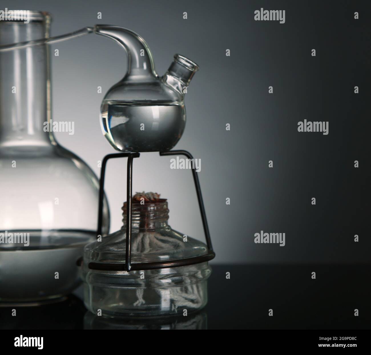 Fixed laboratory glassware on dark background Stock Photo - Alamy