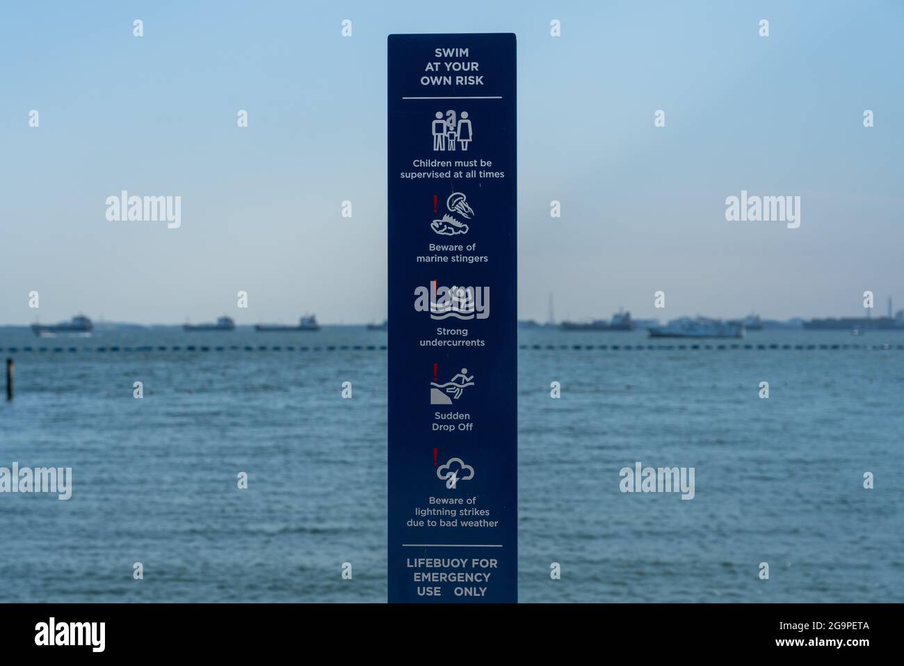 Danger warning sign at the beach agains vessels at sea Stock Photo - Alamy
