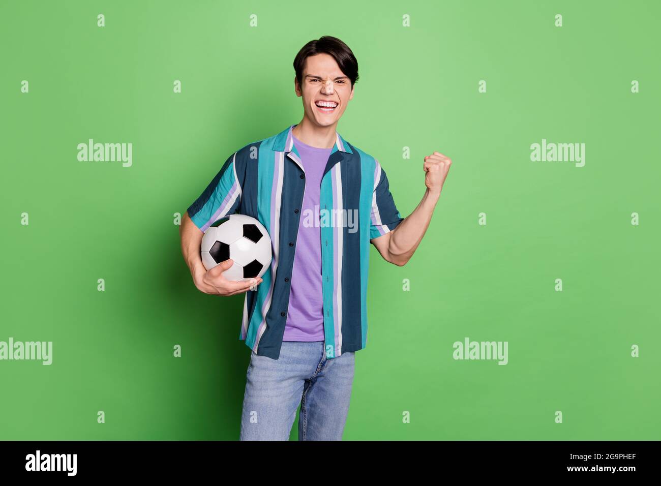 Photo of cheerful young happy positive man hold hands football winner ...