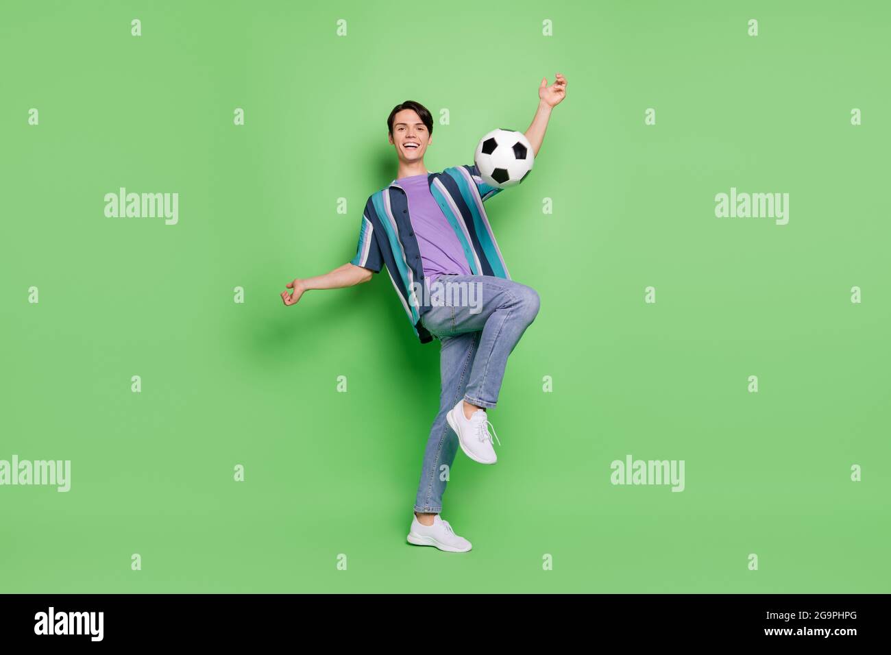 Full size photo of cheerful active joyful happy man kick football smile ...