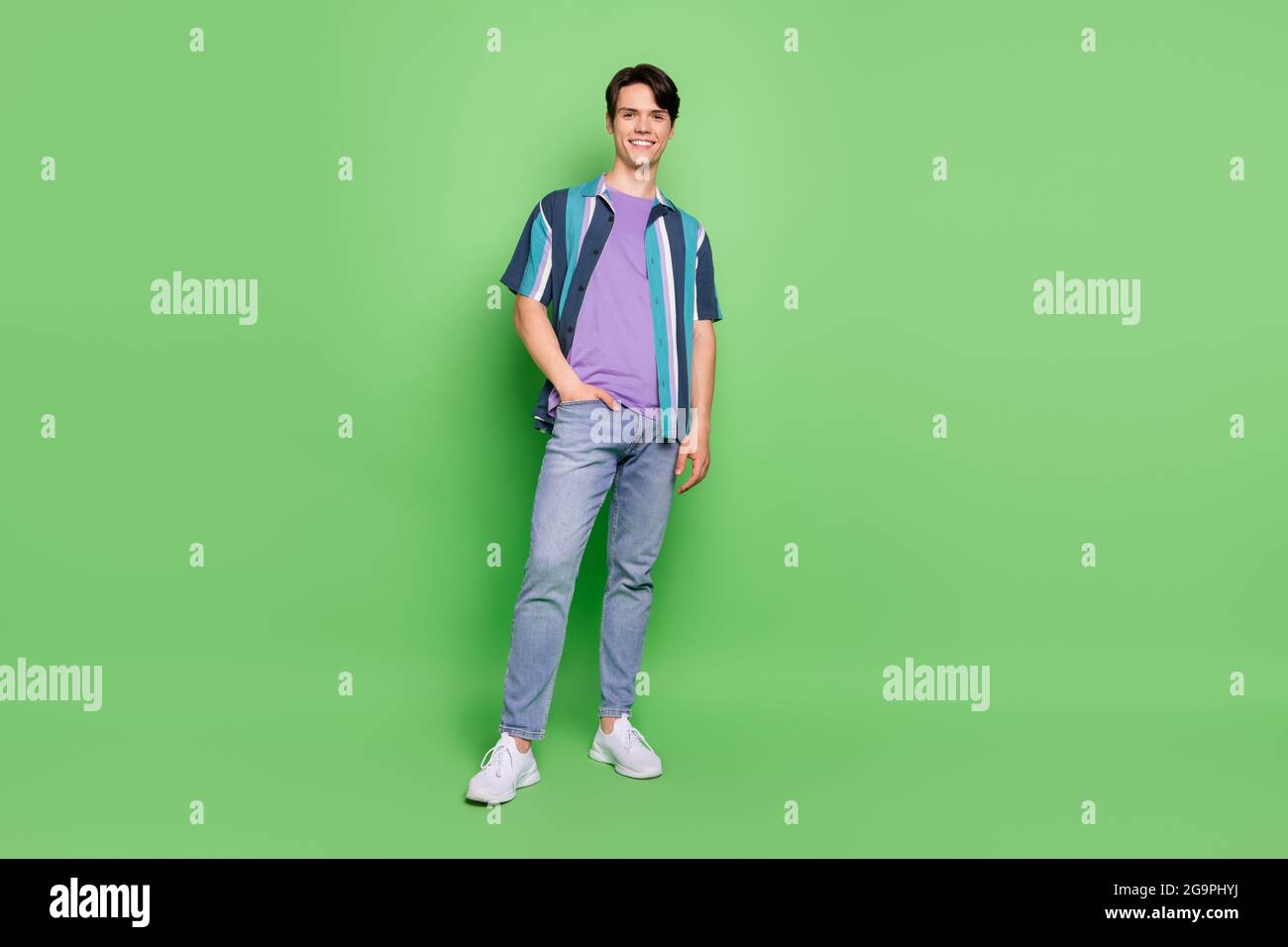 Full body photo of charming attractive young man hold hand jeans pocket ...