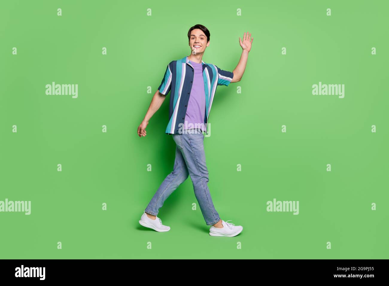 Full body photo of cheerful young happy man wave hello good mood smile ...