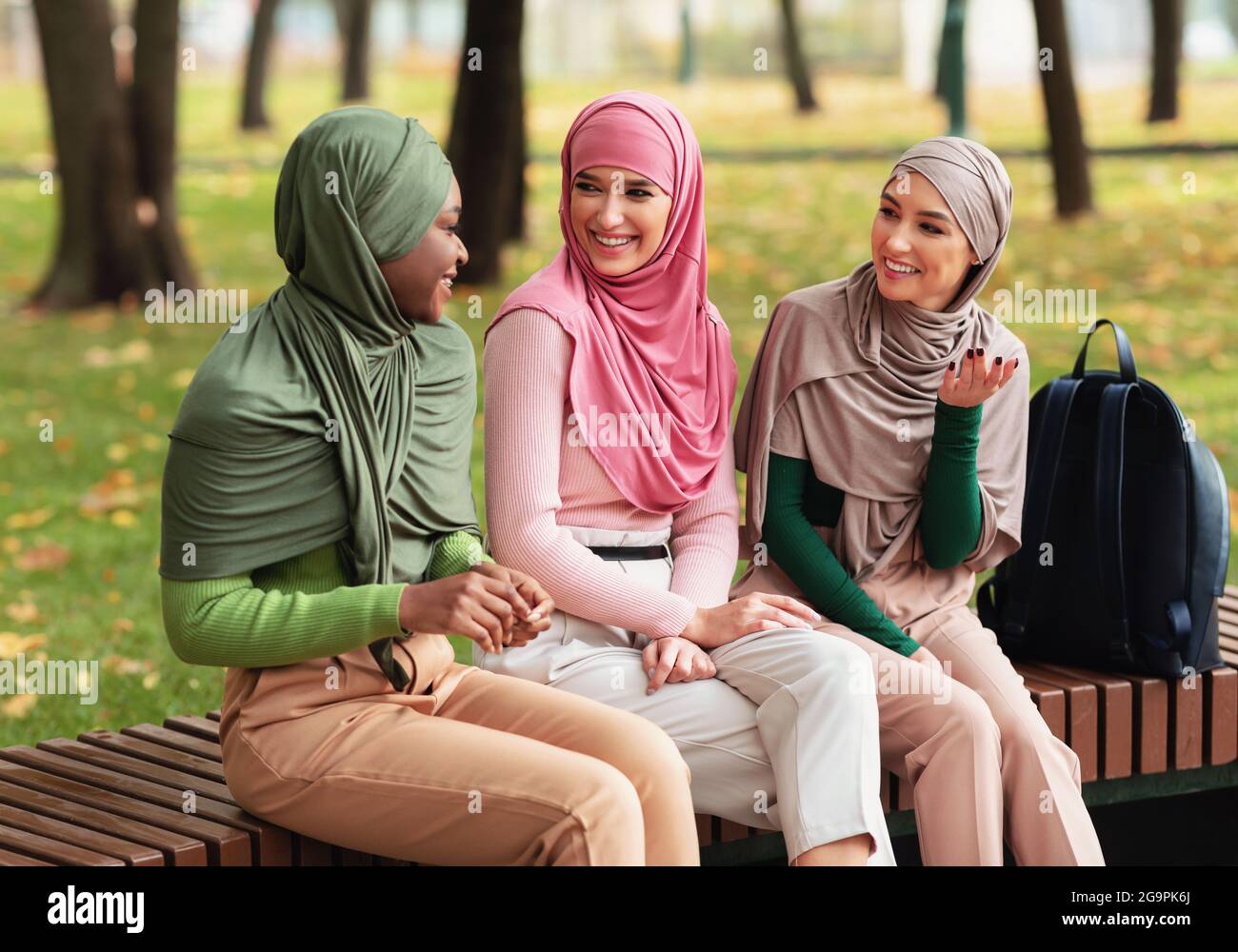 Three Modern Islamic Female Students Spending Time Chatting Outdoors ...