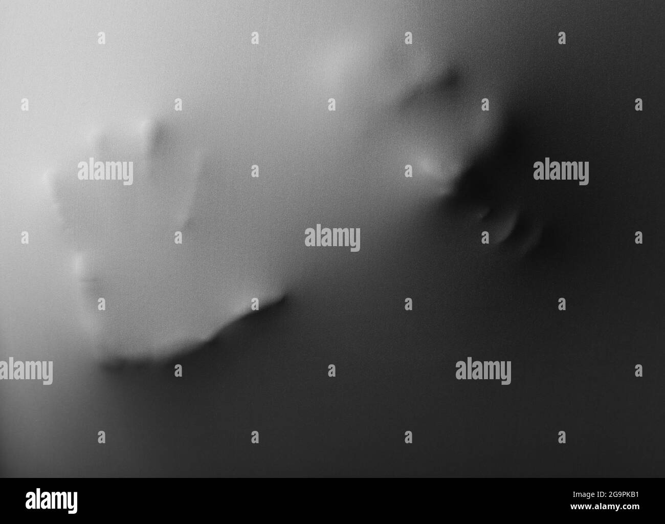 Screaming human face with hand pressing through fabric as horror ...