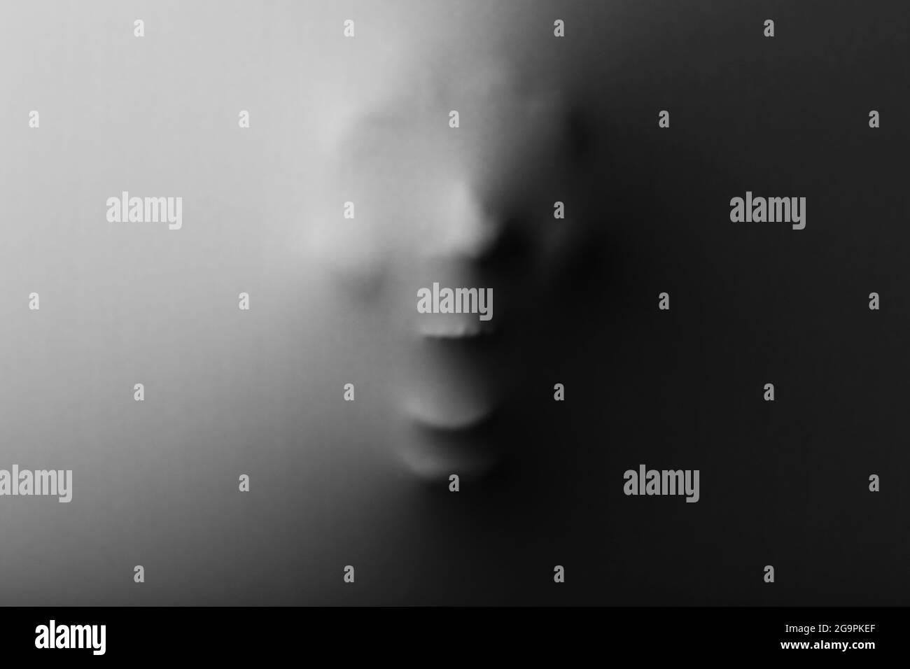 Human face screaming pressing through fabric as horror background Stock ...