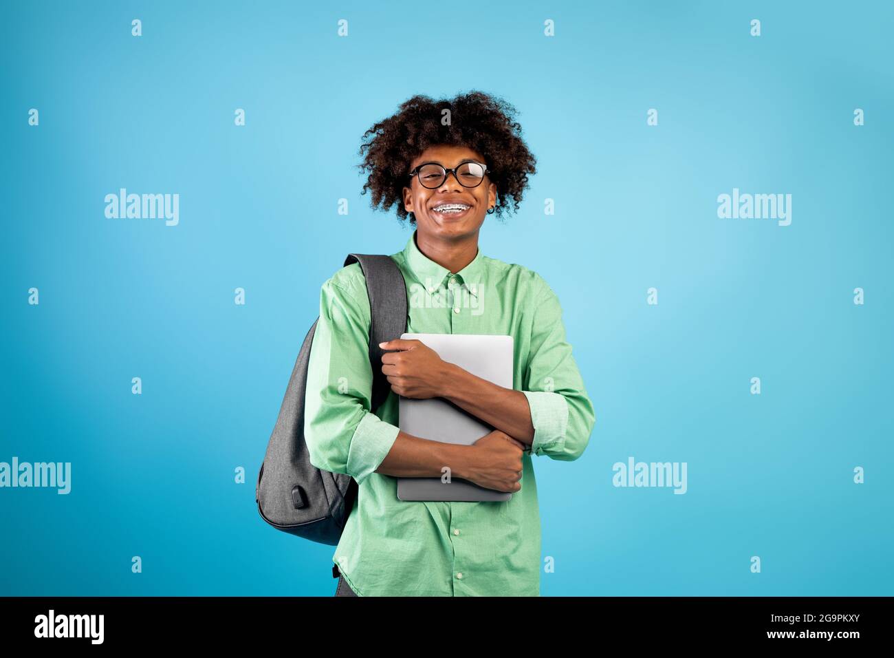 Student's lifestyle concept. Happy african american guy holding laptop ...