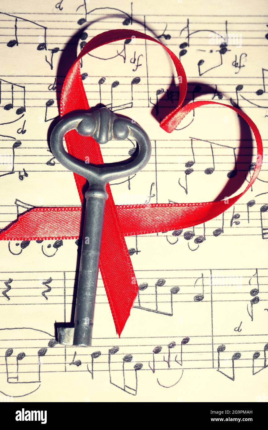 Retro key with heart on music book background Stock Photo - Alamy