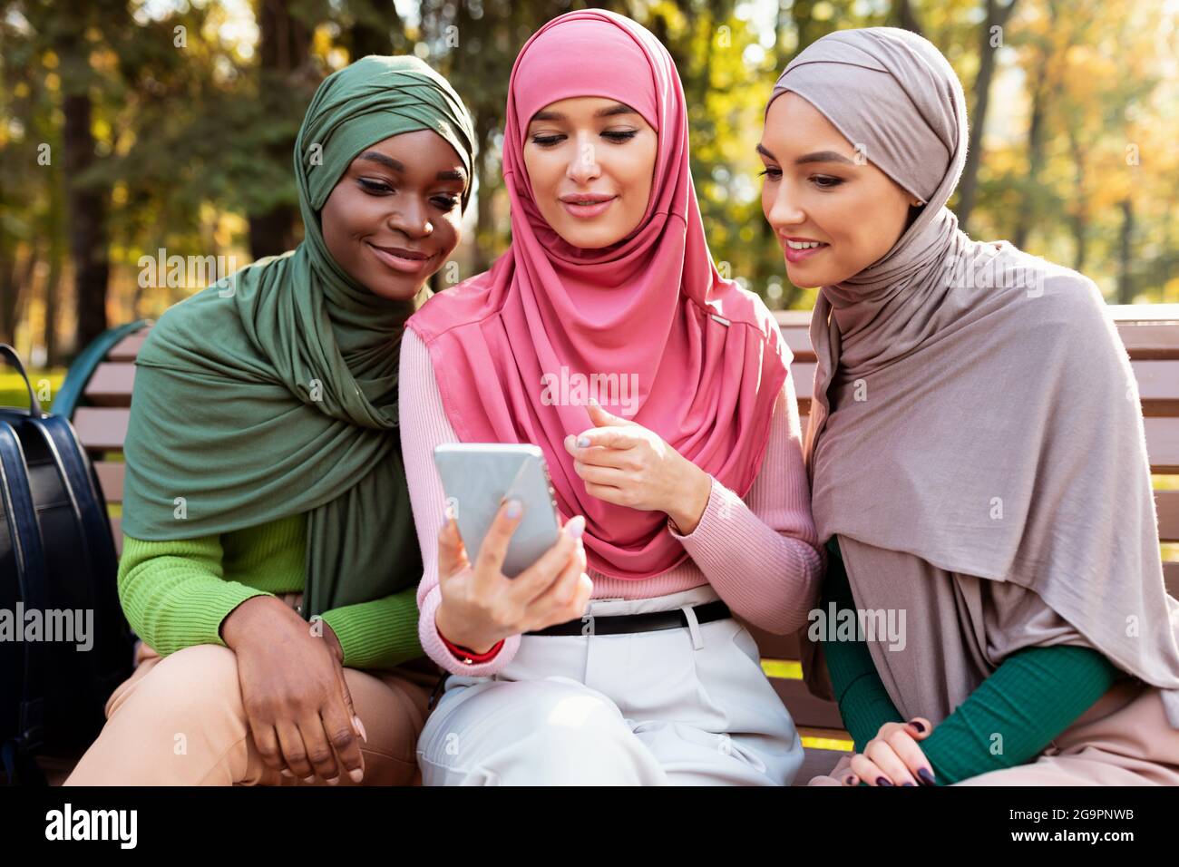 Group Of Muslim Students Women Using Mobile Phone Learning Outdoor ...