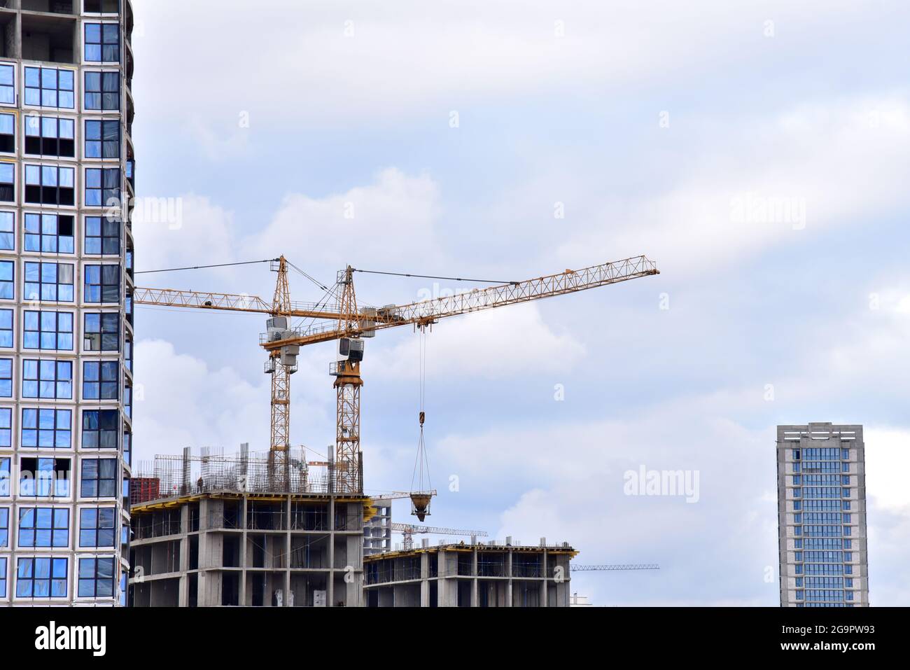 View of a large construction site. Tower cranes in action. Crane and ...