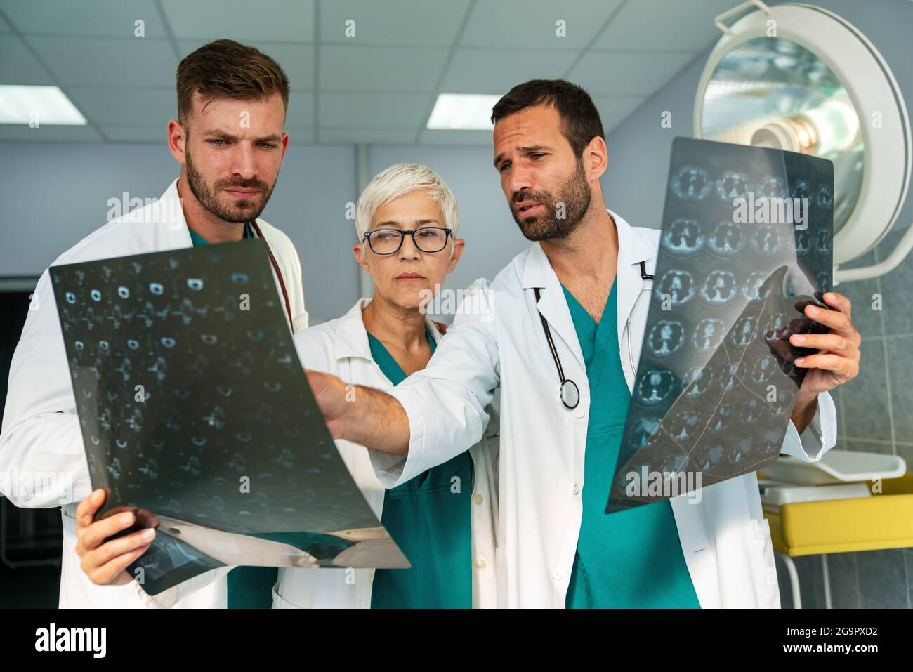 Radiologist doctor consulting with colleagues an x-ray scan in hospital ...