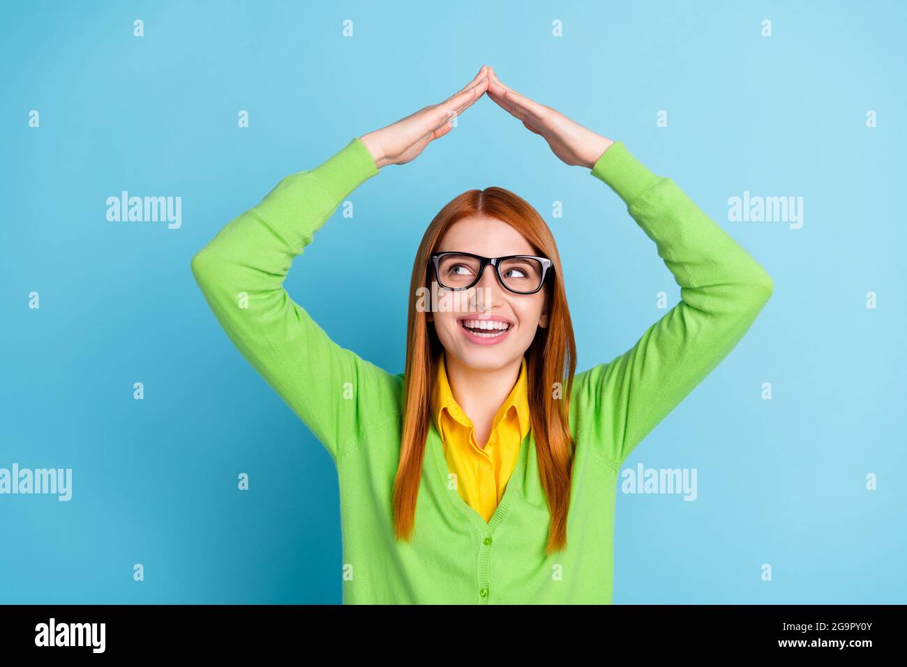 Photo of funny ginger hairdo young lady arms up look up wear spectacles ...