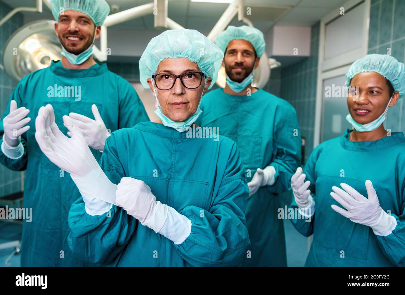 Successful team of surgeon standing in operating room, ready to work on ...