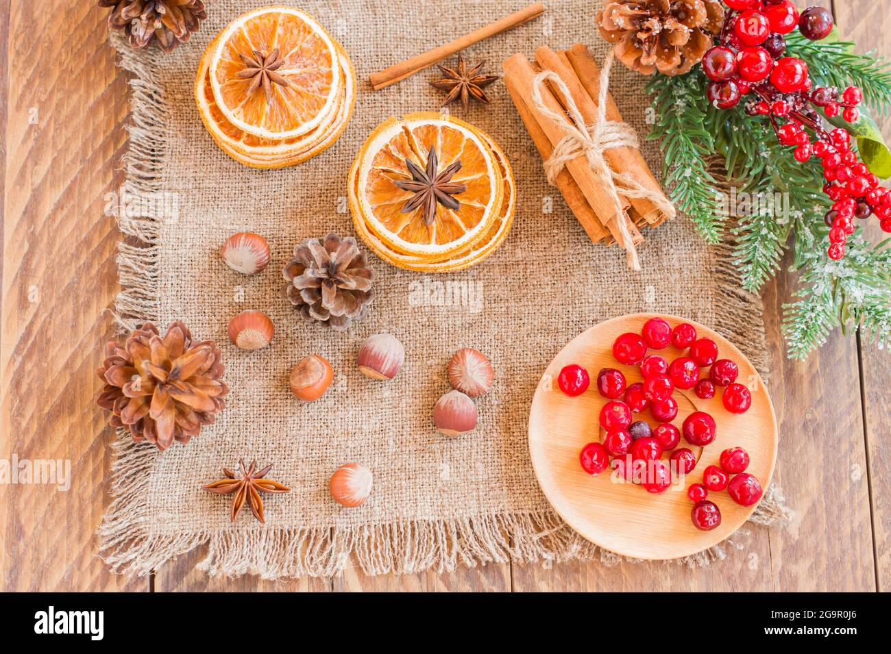 Dried orange slices, cinnamon and star anise on wooden table with copy ...