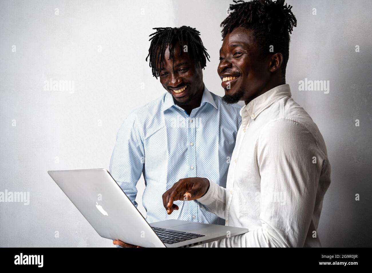 Two Men with a Laptop Stock Photo - Alamy