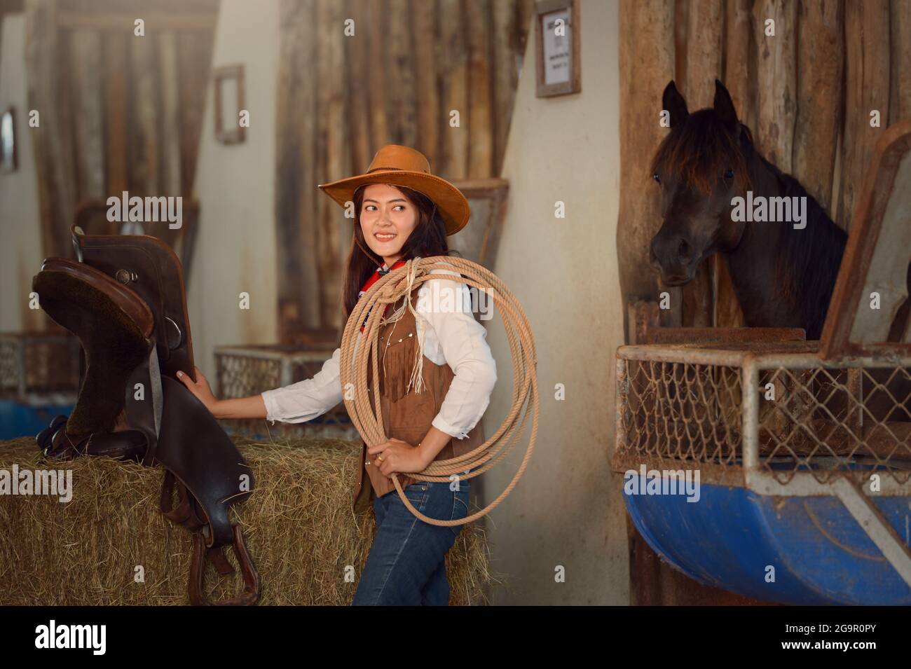 Cowgirl working stables.Concept of retro woman in horse ranch.vintage ...