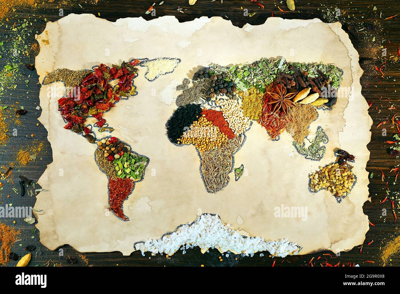 Map of world made from different kinds of spices on wooden background ...