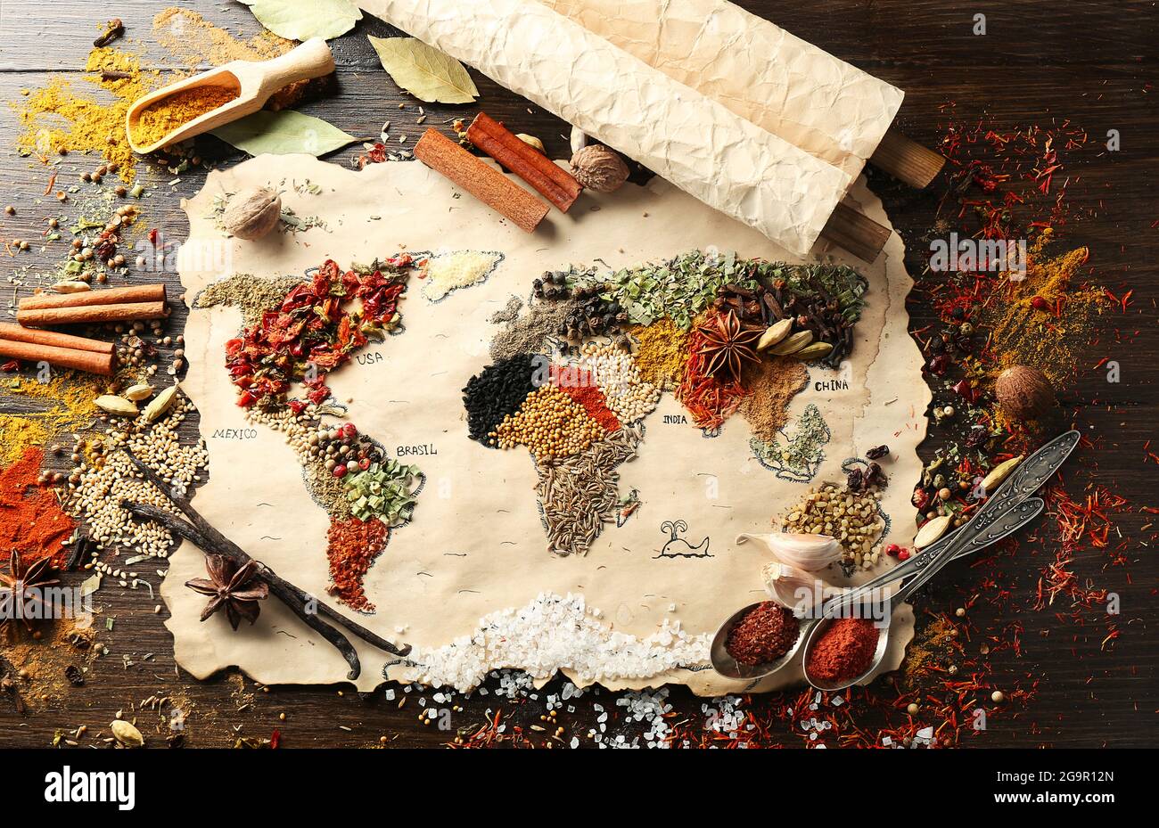 Map of world made from different kinds of spices on wooden background ...