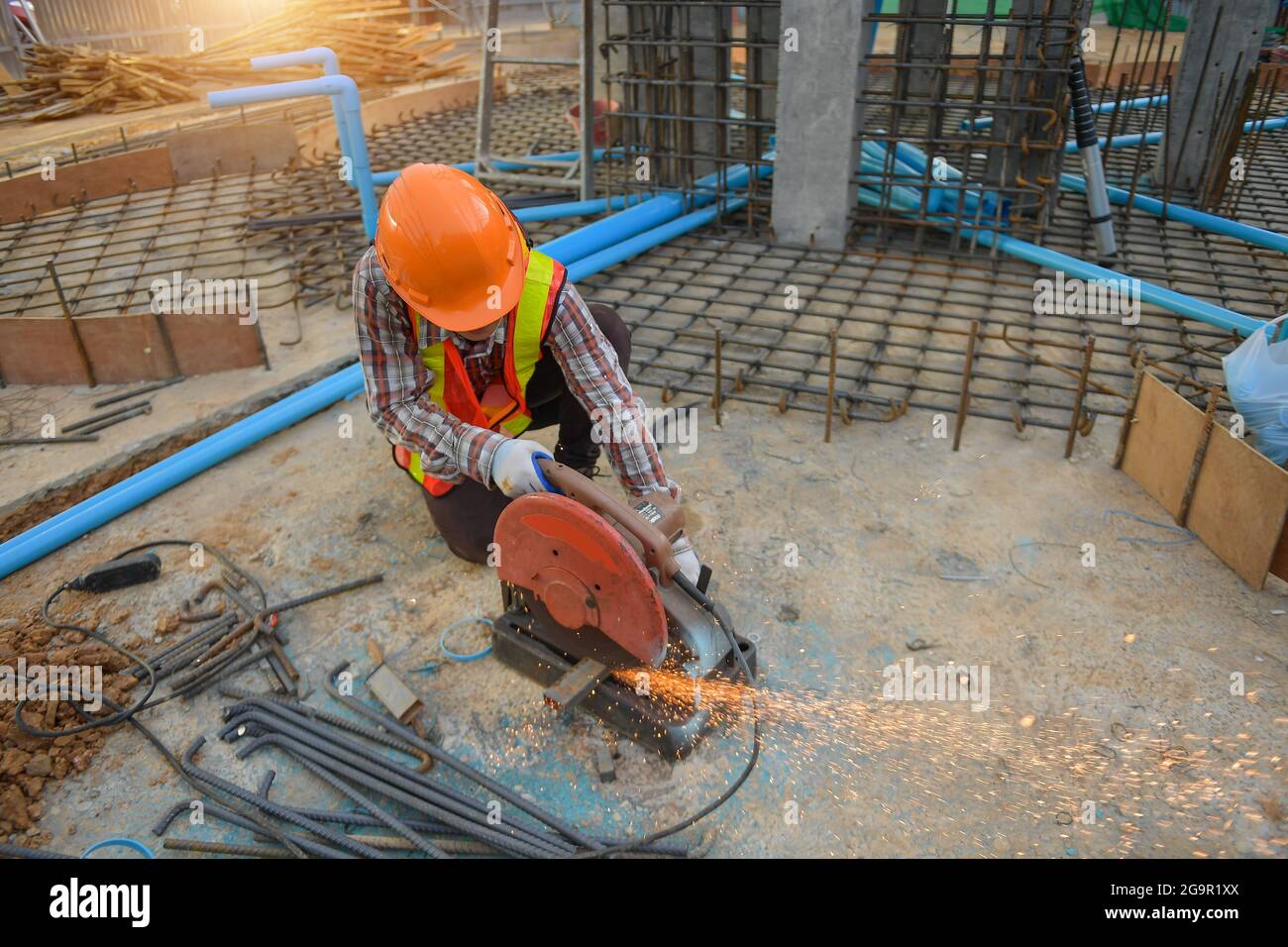 Worker cut steel with cutting machine circular disc cuts off part of ...
