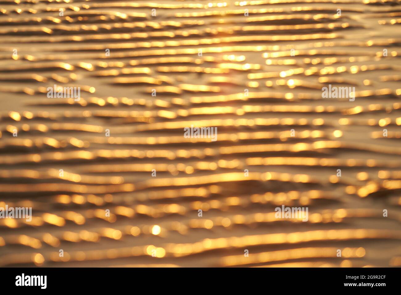 Sand waves texture with water on the sea beach. Yellow sand texture for ...